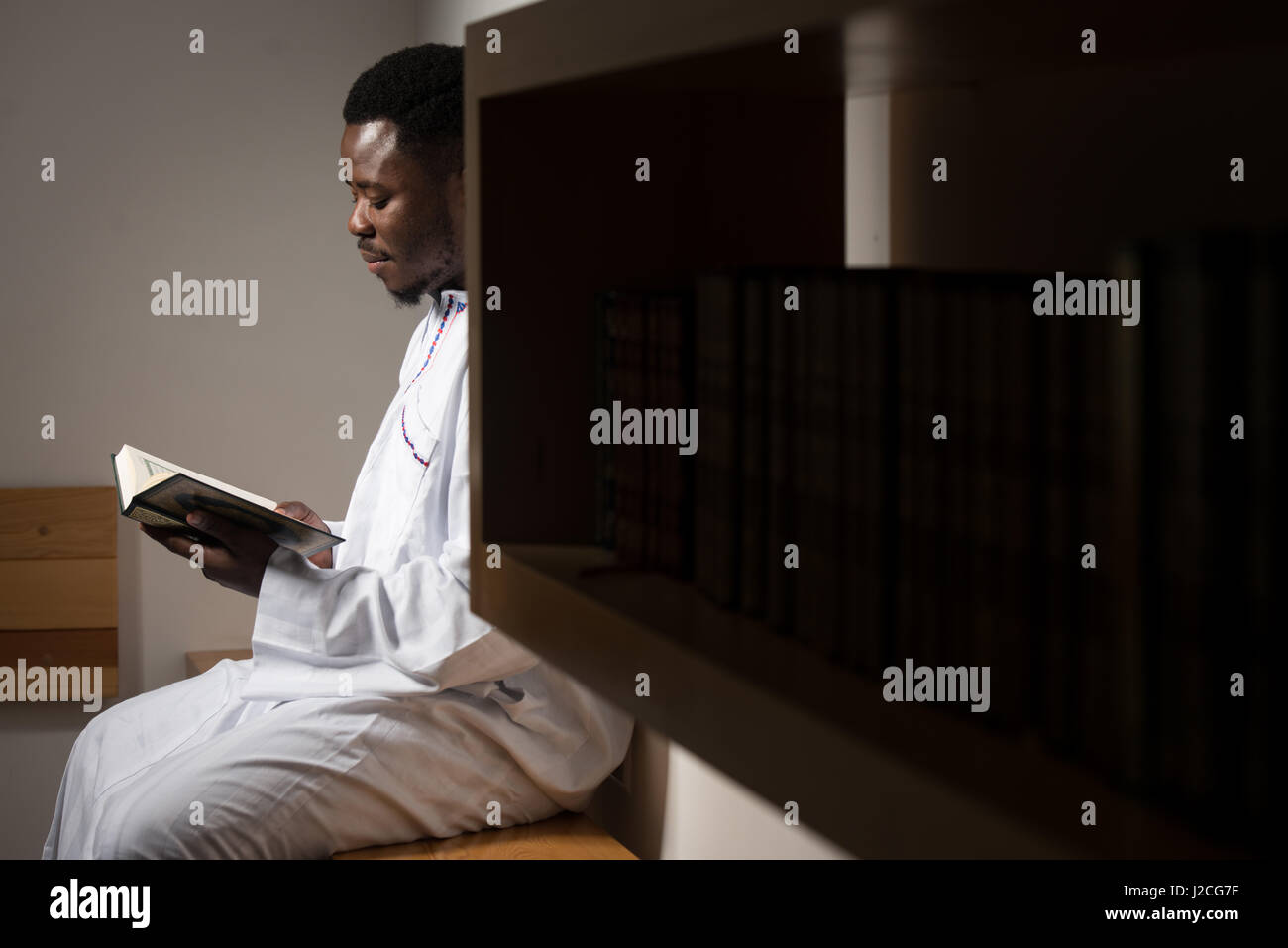 Black African Muslim Man Reading Holy Islamic Book Koran Stock Photo ...