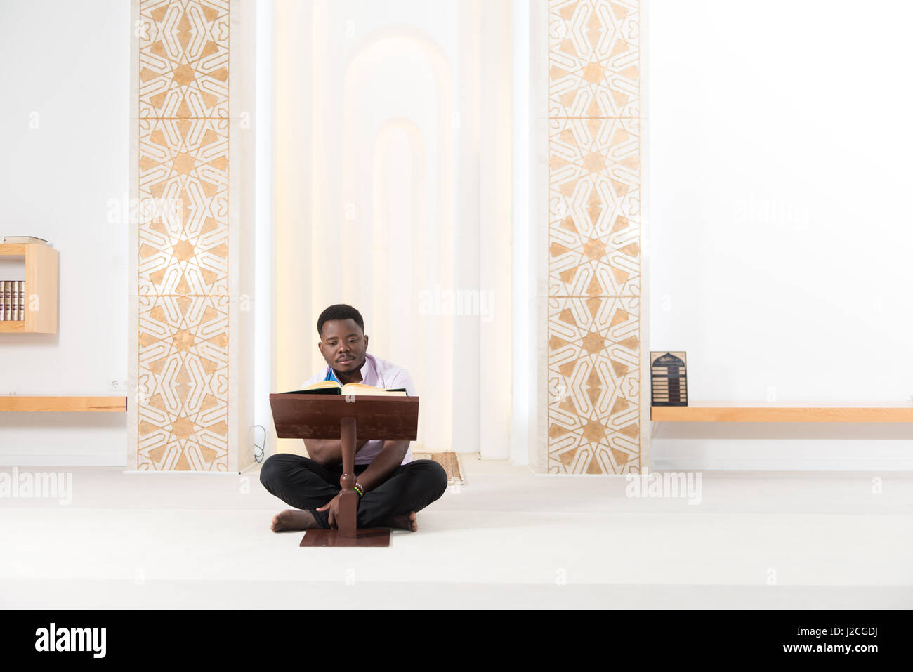 Black African Muslim Man Is Reading The Koran Stock Photo - Alamy