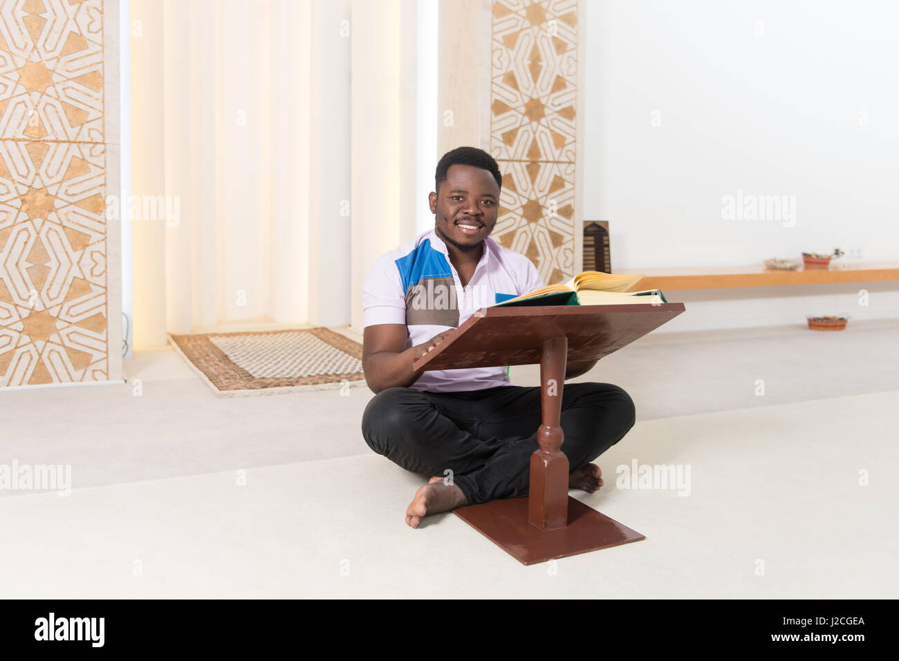 Black African Muslim Man Is Reading The Koran Stock Photo - Alamy