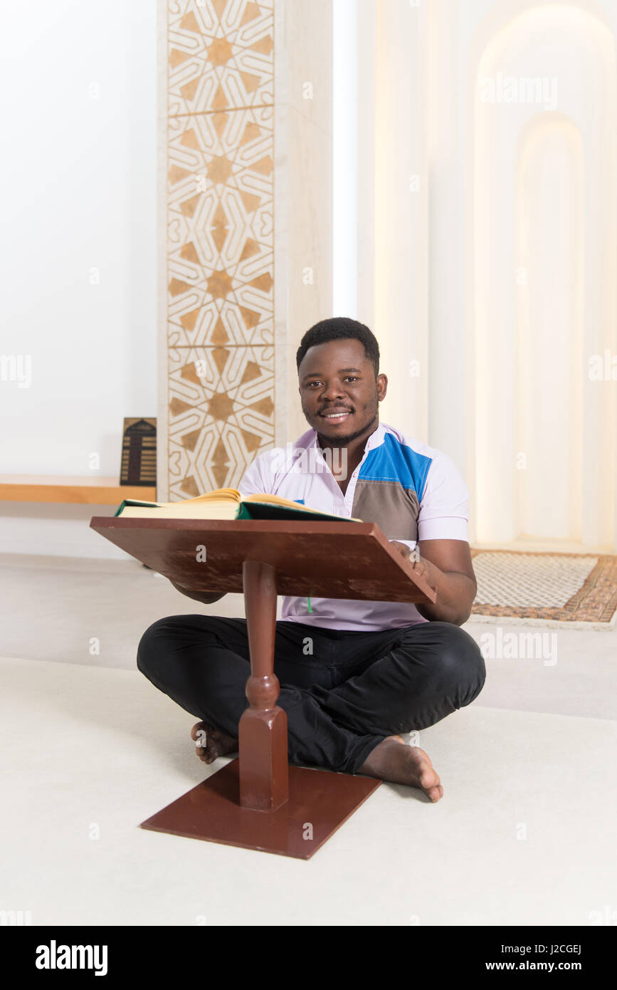 Black African Muslim Man Is Reading The Koran Stock Photo - Alamy