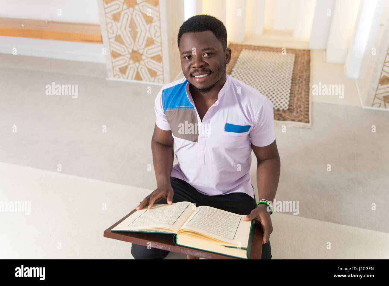 Black African Muslim Man Is Reading The Koran Stock Photo - Alamy