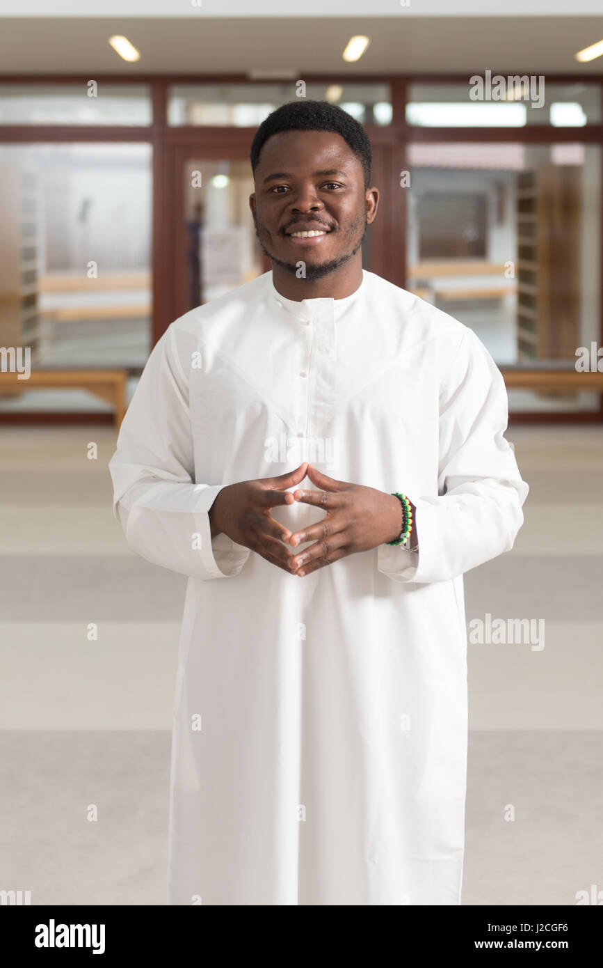 African Muslim Man Making Traditional Prayer To God While Wearing A ...