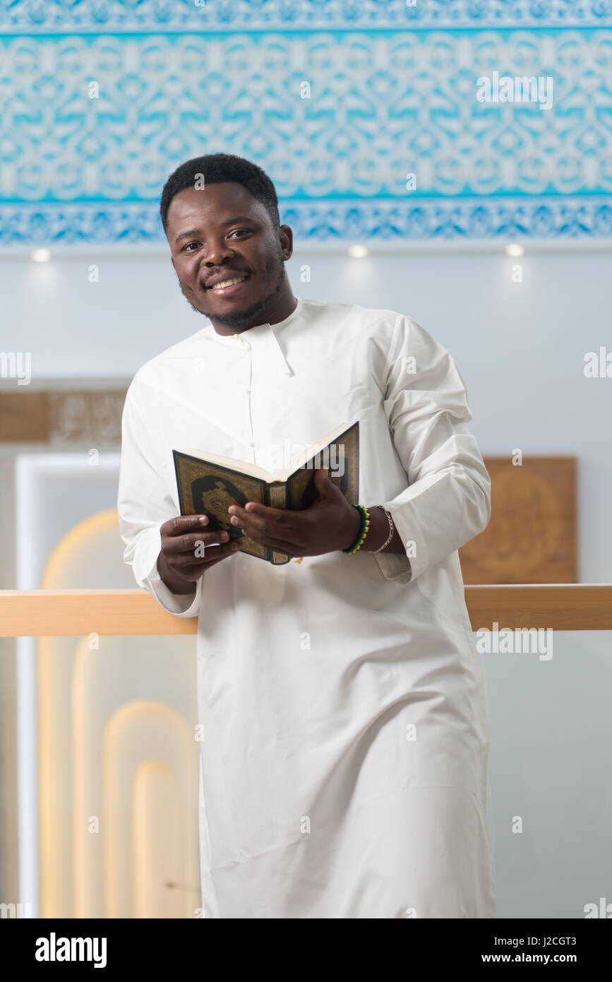 Black African Muslim Man Reading Holy Islamic Book Koran Stock Photo ...