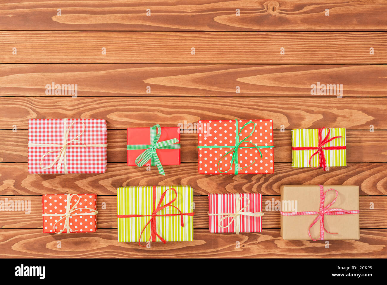 Overhead shot of christmas presents on wooden table Stock Photo - Alamy