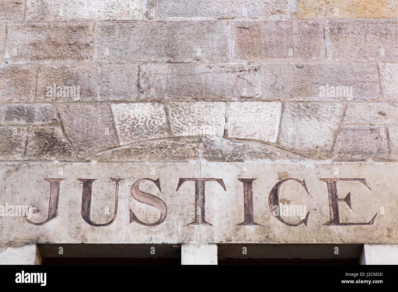 Justice sign on a wall Stock Photo - Alamy