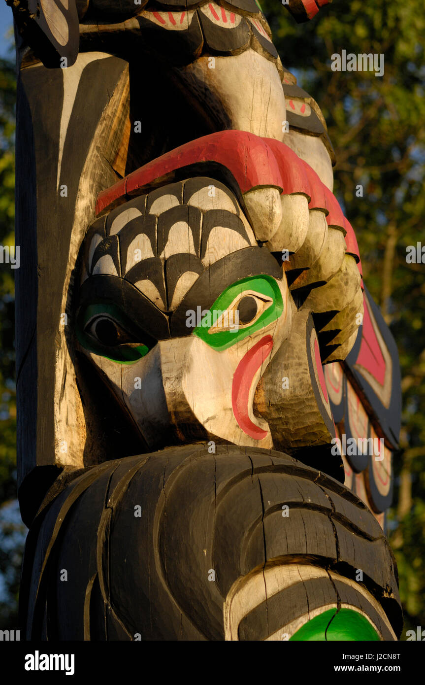 Canada, British Columbia, Vancouver Island. Raven Holding Totem Pole ...