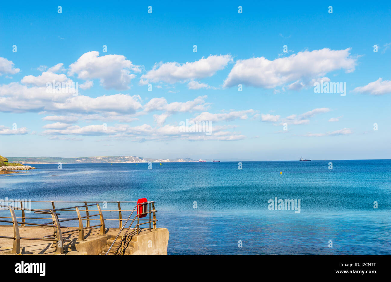 View of the enormous ocean, part of the promenade with lifebuoy, a ...