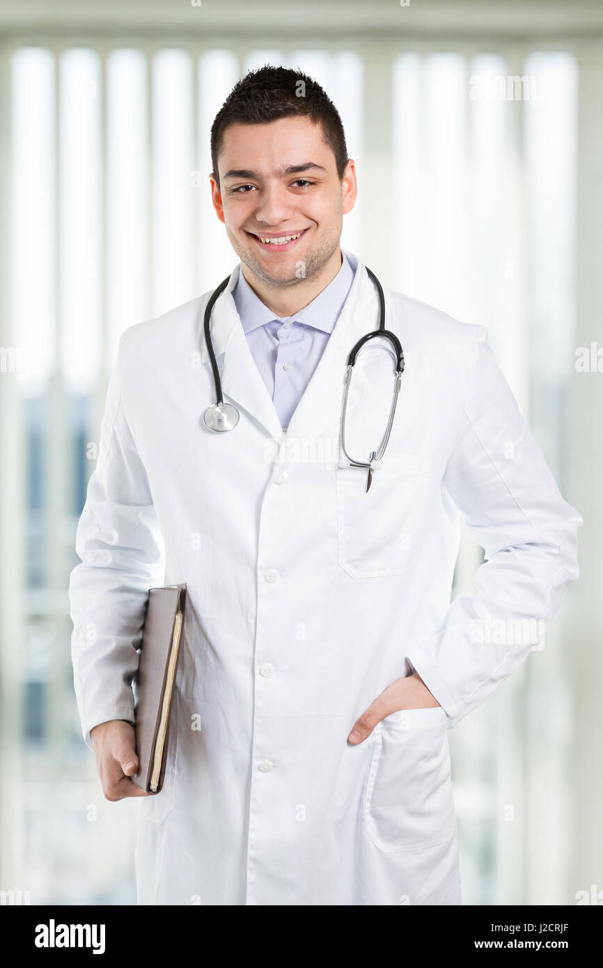 Male doctor holding reports. Doctor at office Stock Photo - Alamy