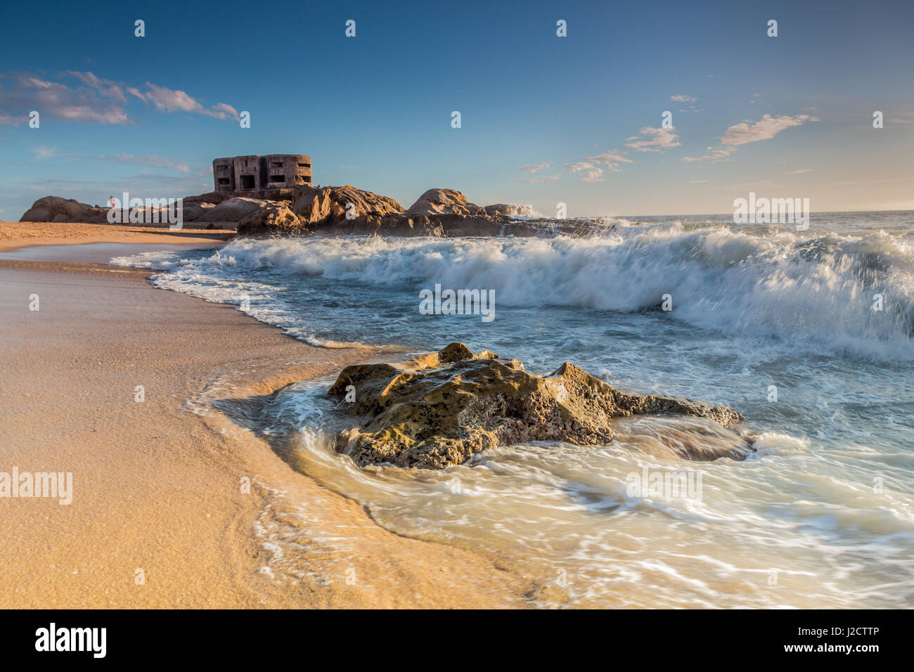 Big military bunker and waves crashing on beach shore, in Cadiz, Spain ...