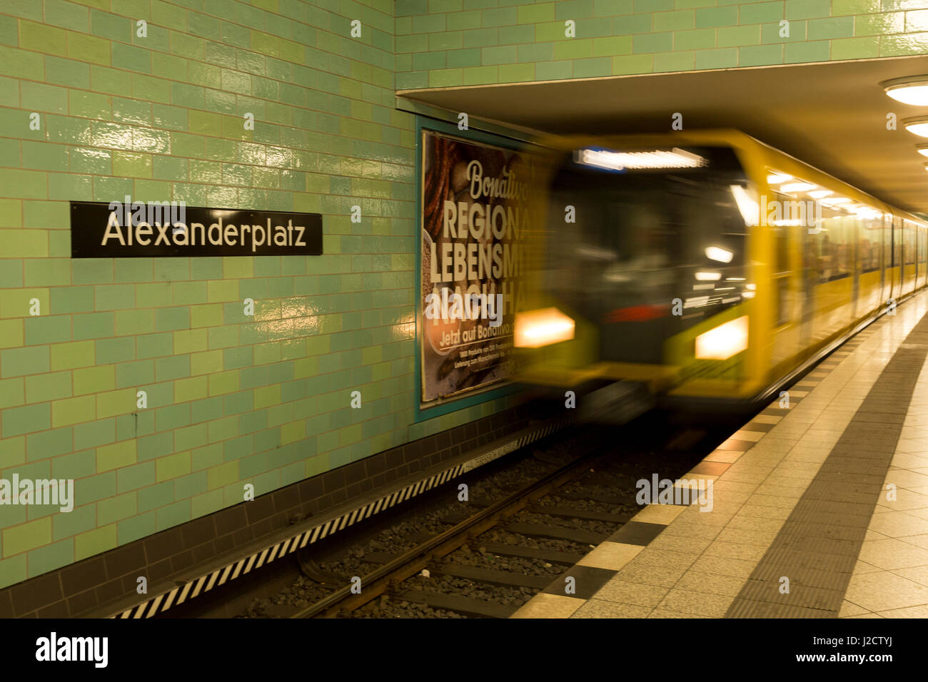 Germany, Berlin. Train arriving at Alexanderplatz subway station ...