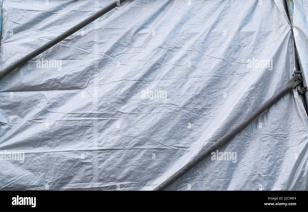 gray tarp covering a building for backgrounds Stock Photo - Alamy