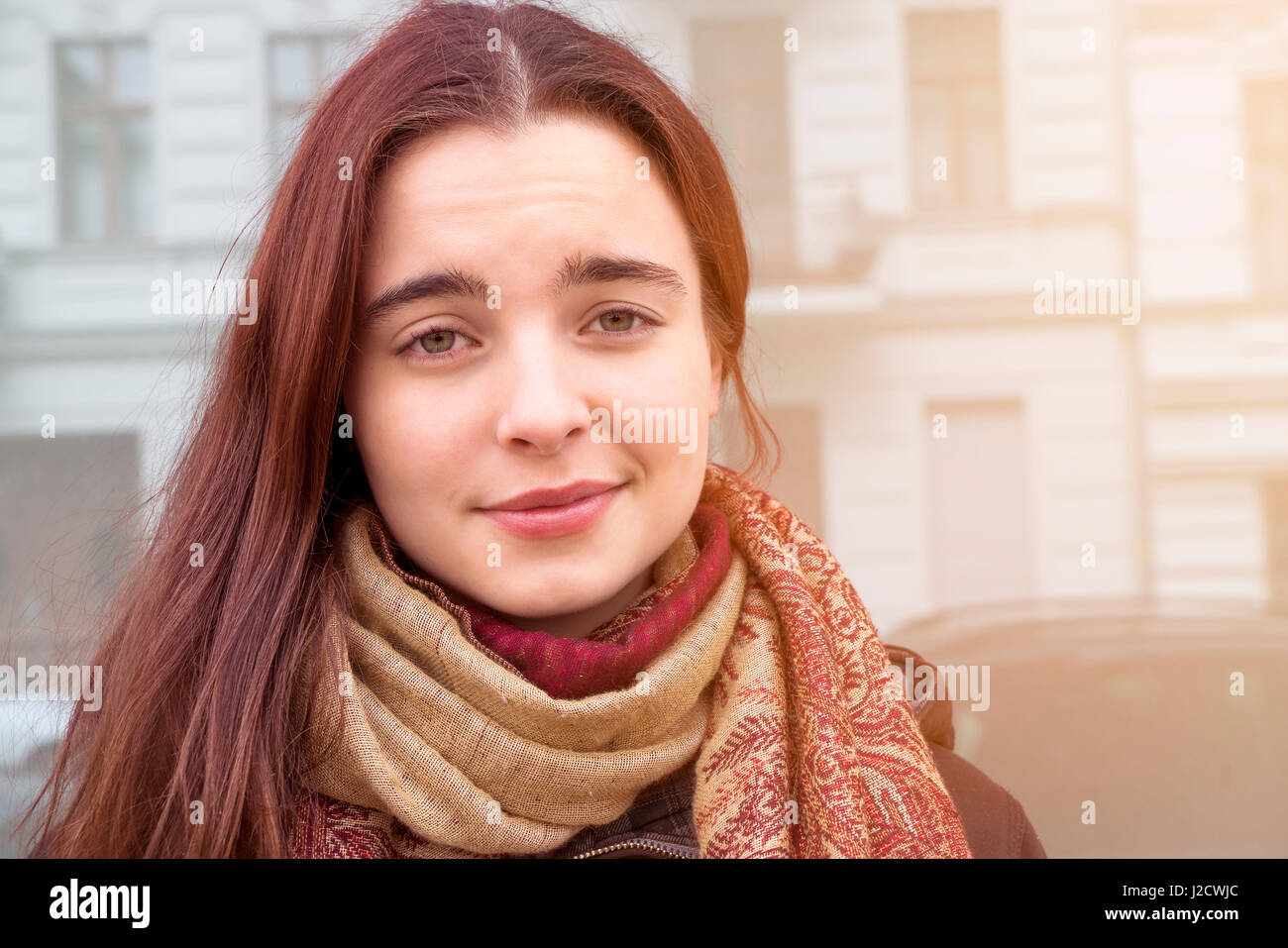 portrait of a smiling woman in front of a window Stock Photo - Alamy
