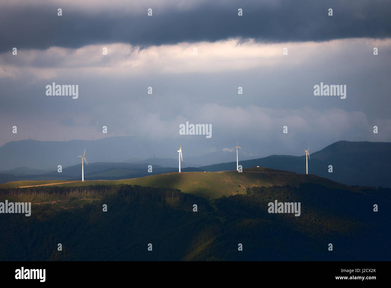 Four wind turbines located on the ridge at sunset Stock Photo - Alamy