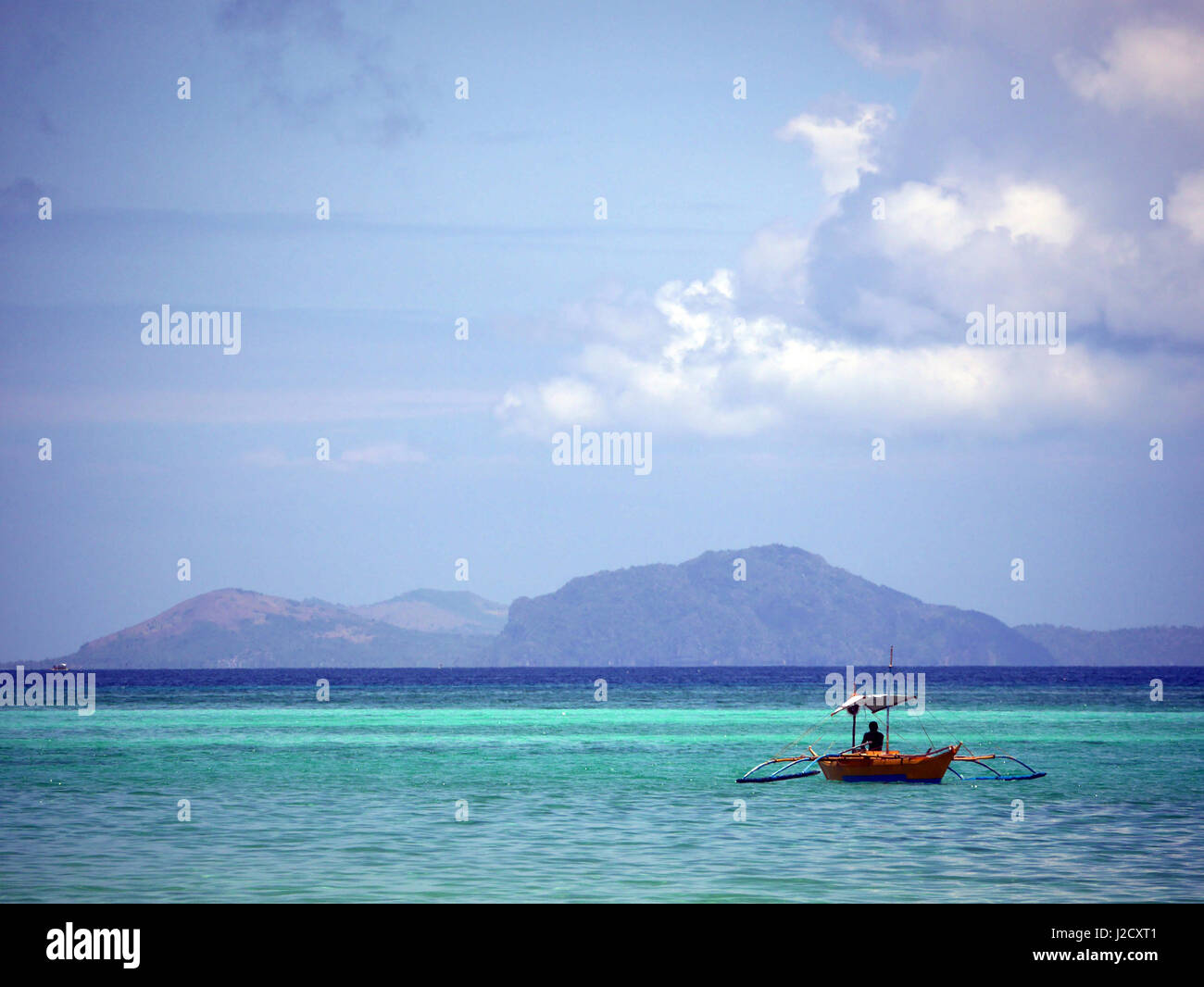 Philippines, Western Visayas, Iloilo, Sicogon, outrigger in turquoise ...