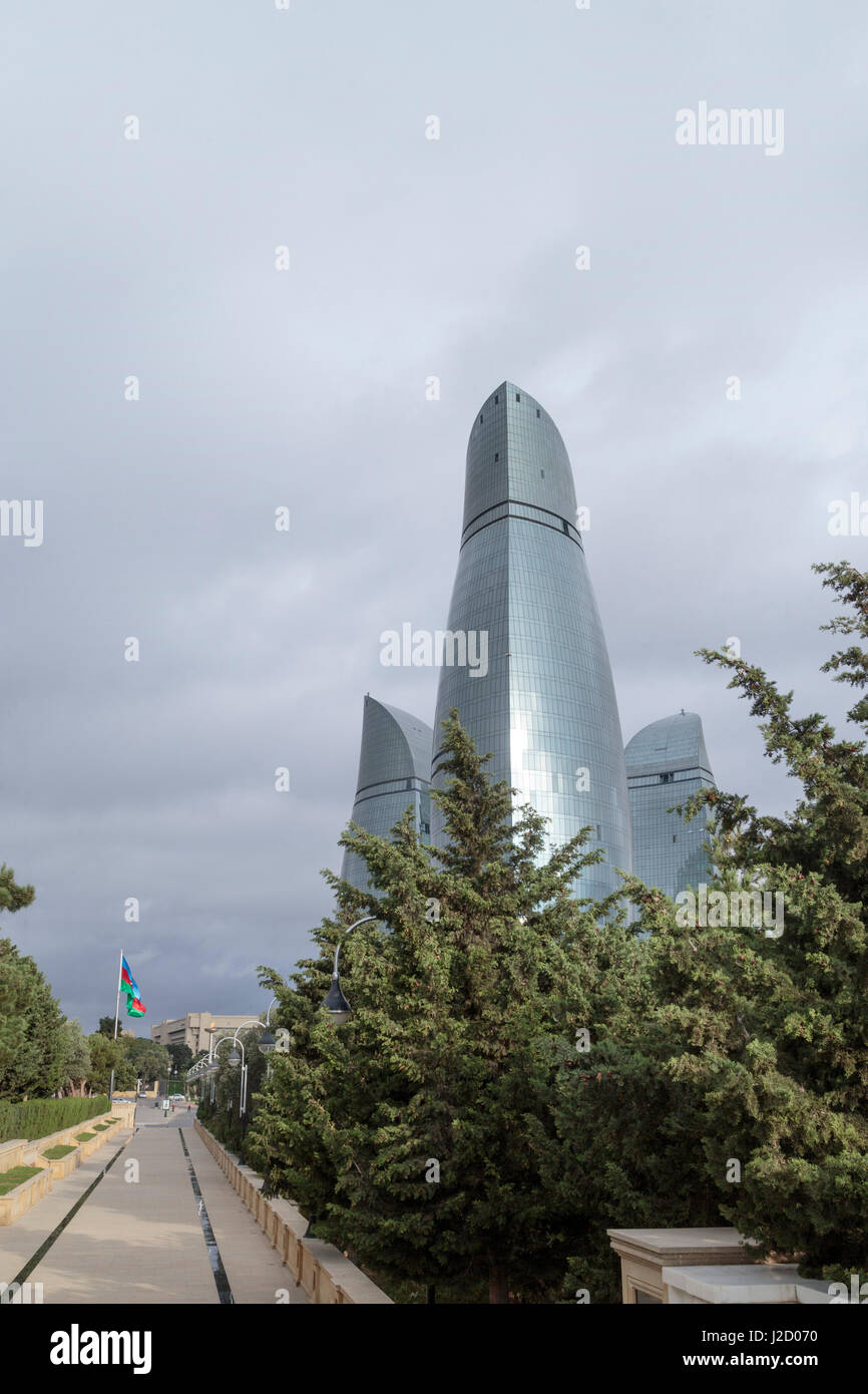 Azerbaijan, Baku. A walkway in Dagustu park, with the Flame Towers in ...