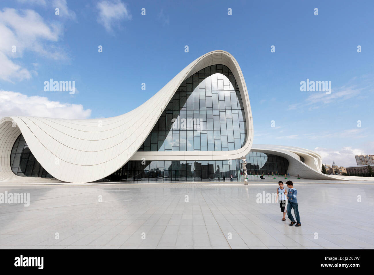 Azerbaijan, Baku. Kids walking in front of the Heydar Aliyev Center in ...