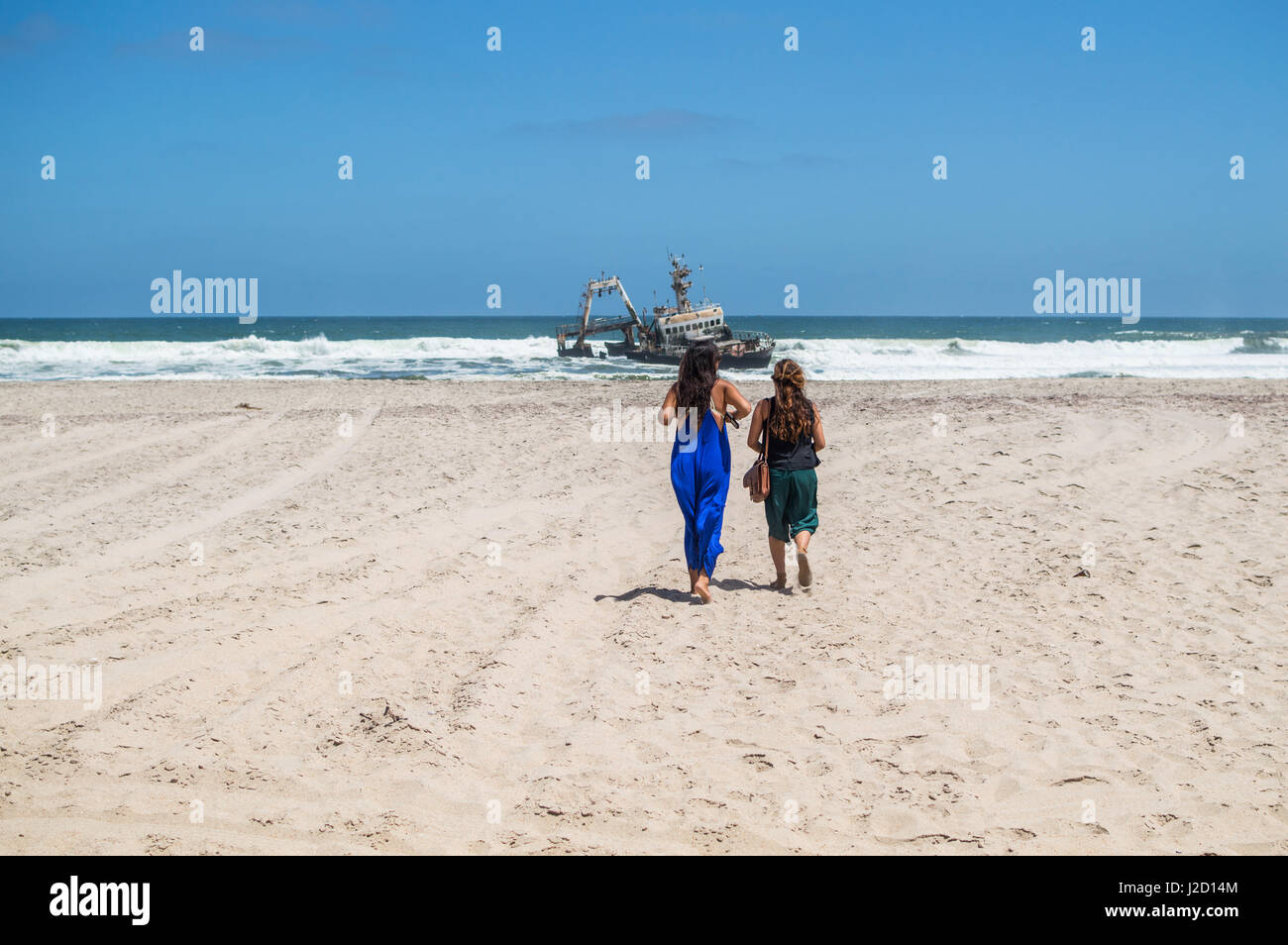 Two Women and a Shipwreck Just off a Beach near Swakopmund along ...