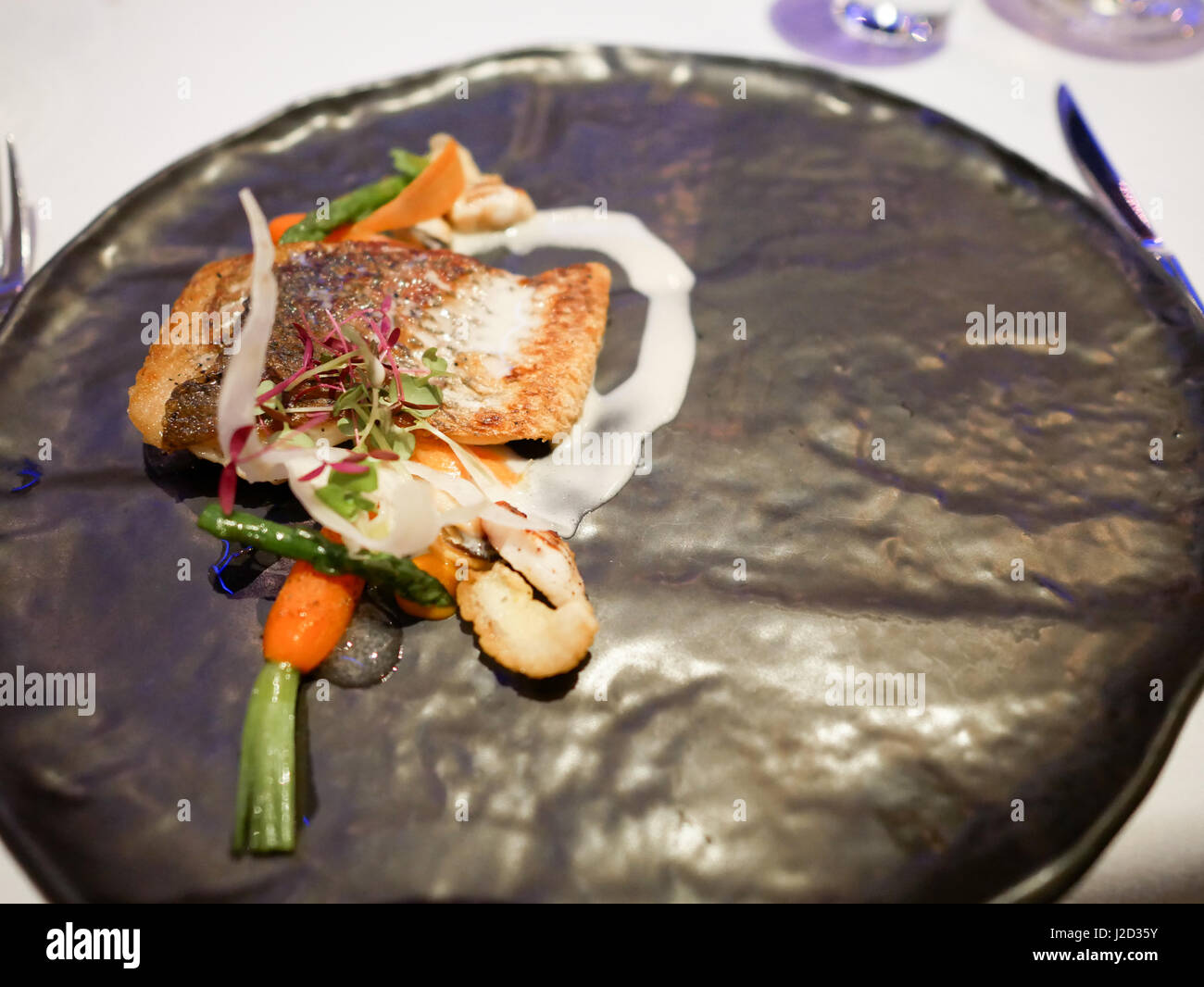 Grilled fish dish in fine dining restaurant Stock Photo - Alamy