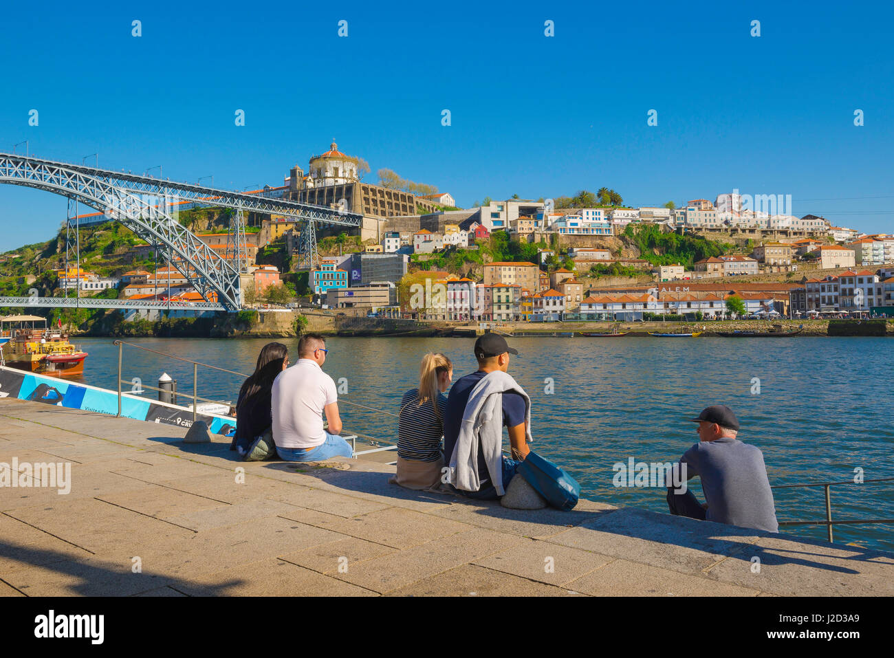 Ribeira Porto Portugal, rear view of people sitting along the Ribeira ...