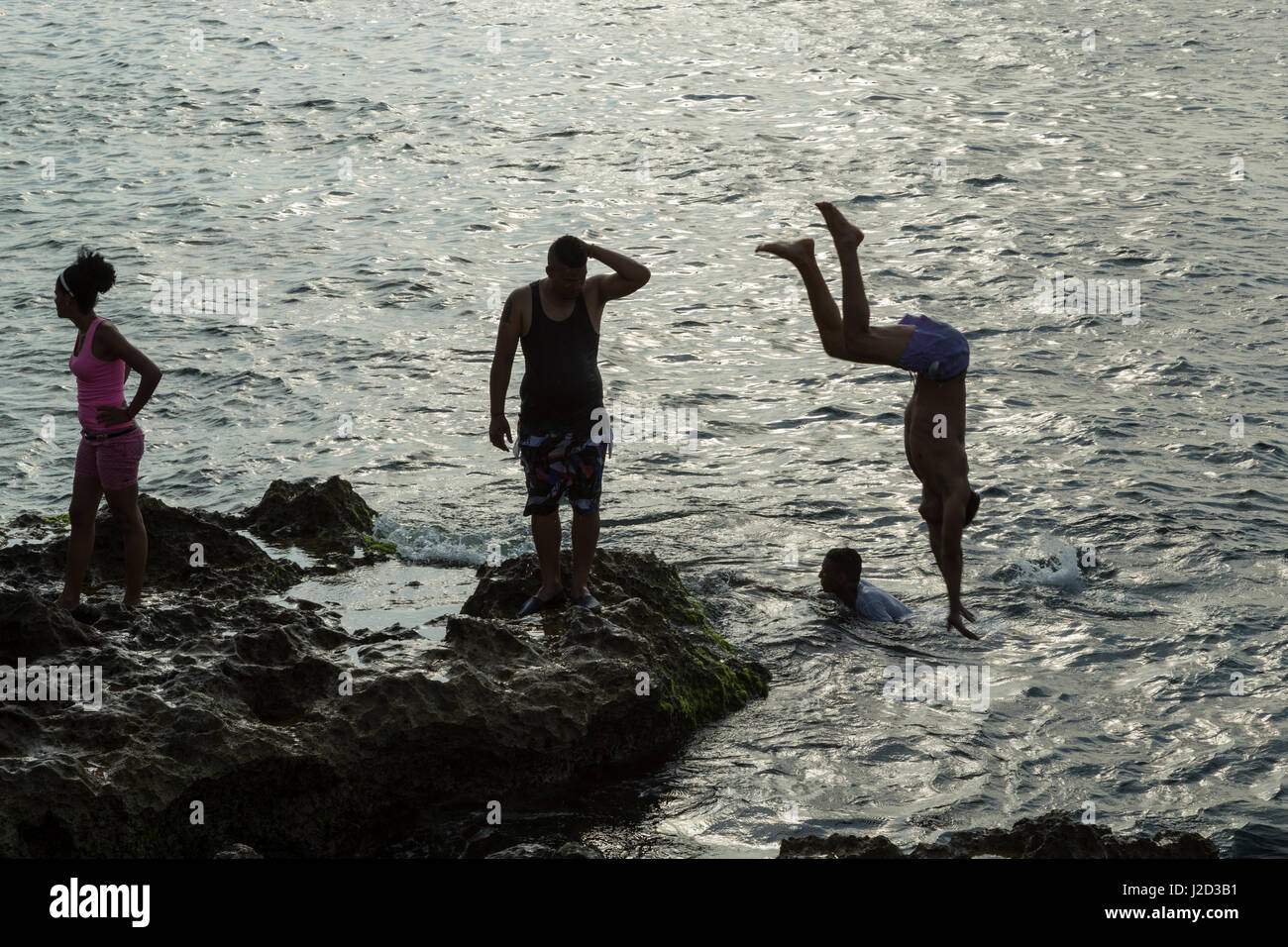 Cuba, Havana. Swimmers diving into the bay along the Malecon Stock ...