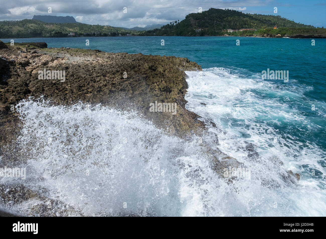 Cuba, Baracoa. Ocean waves and rainbow along the rugged coastline of ...