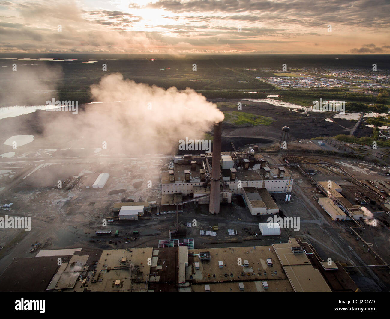 Canada, Manitoba, Aerial view of smoke pouring from tall stack at ...
