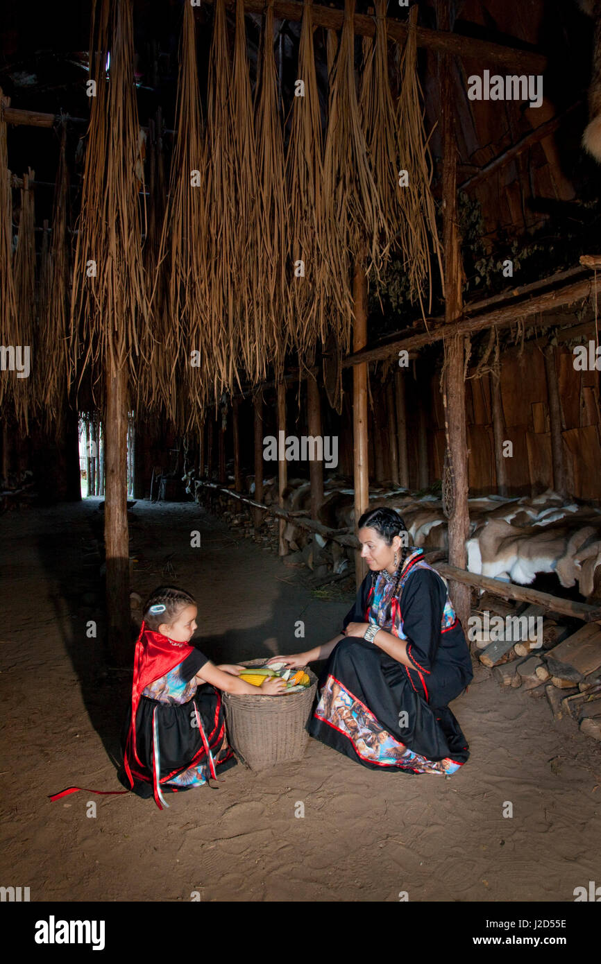 Ojibwe mother and daughter dressed in traditional ribbon dresses with a ...