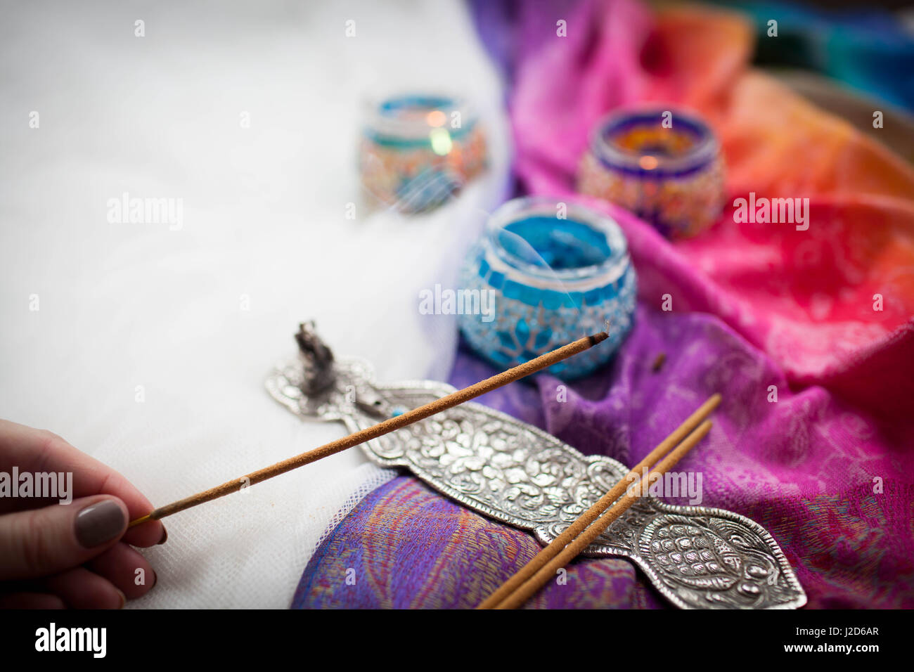 hand holding incense on white background Stock Photo - Alamy