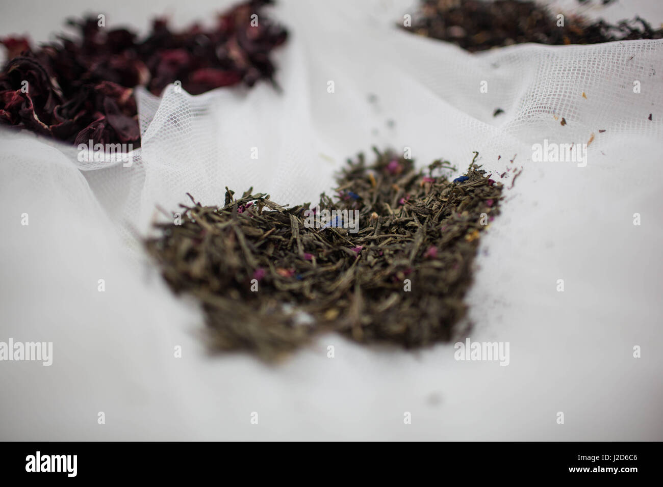 a bunch of green tea lies on white table Stock Photo - Alamy