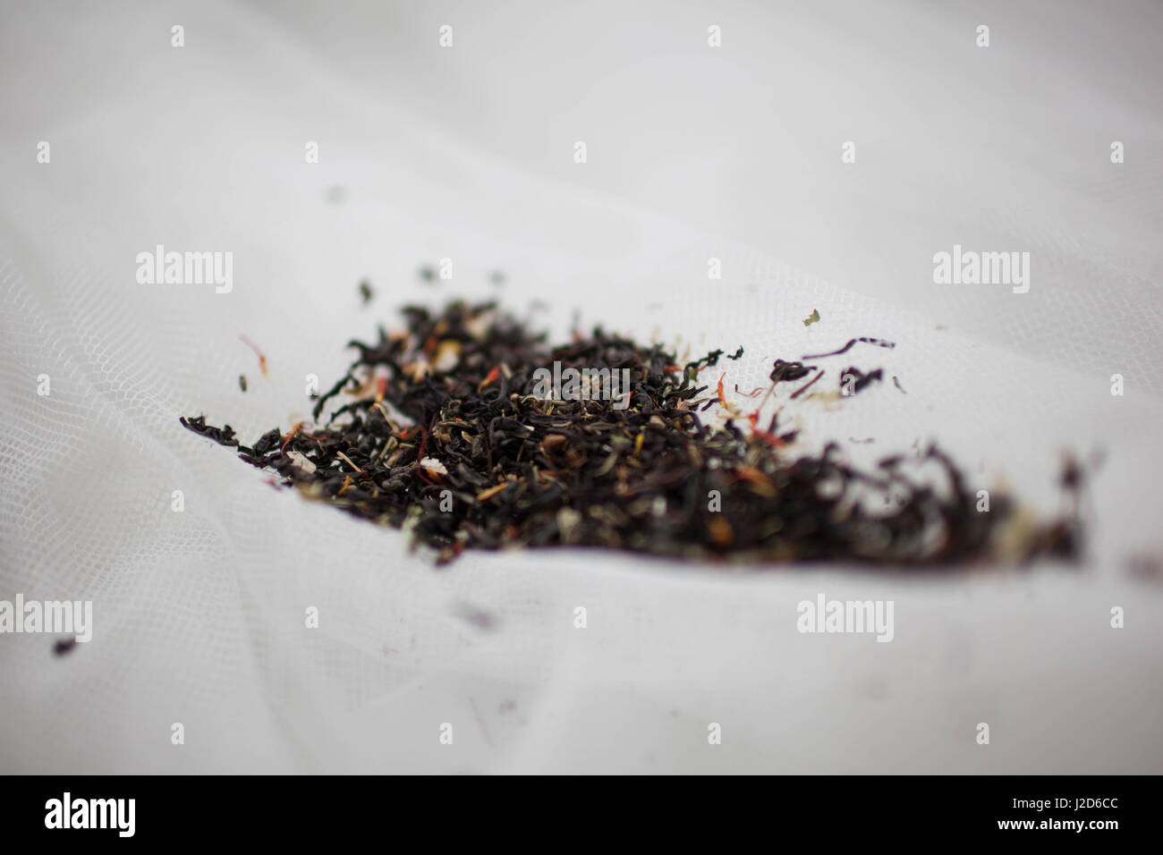 a bunch of green tea lies on white table Stock Photo - Alamy