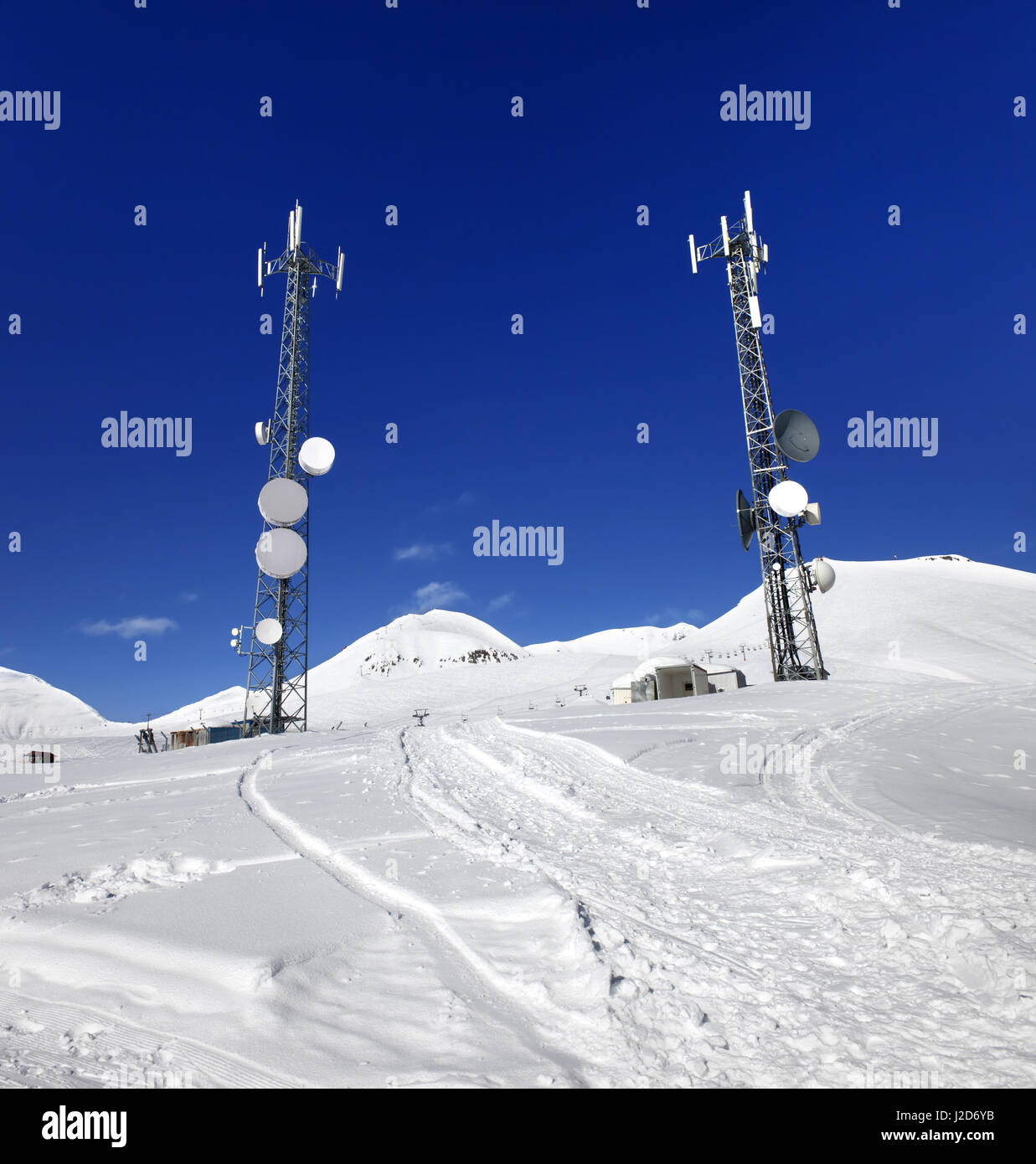 Ratrac ski road and satellite dishes at nice sun day in winter ...