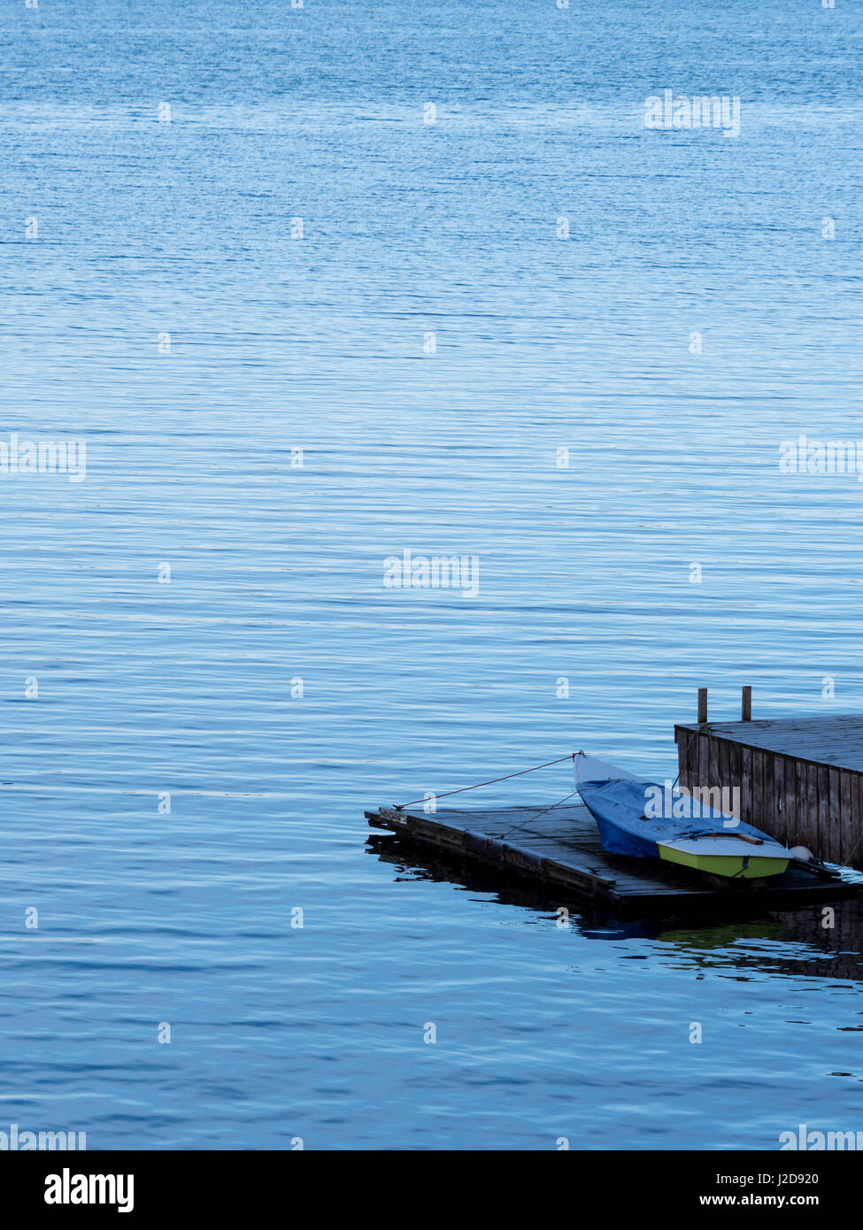 small boat, wooden dock, portrait orientation Stock Photo - Alamy