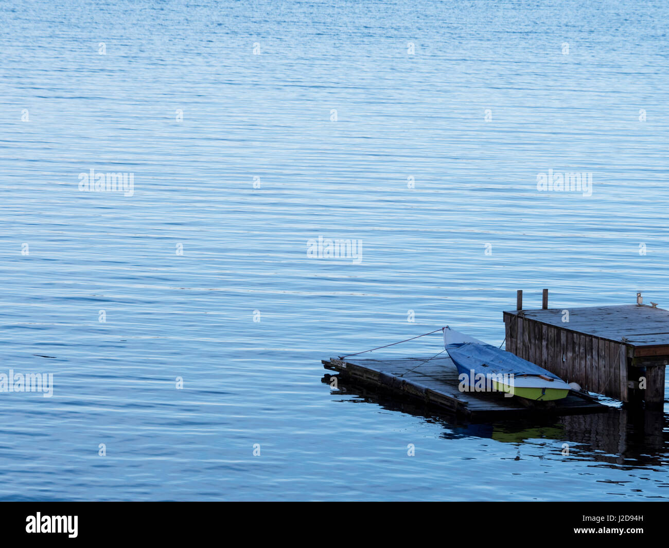 small boat, wooden dock, landscape orientation Stock Photo - Alamy