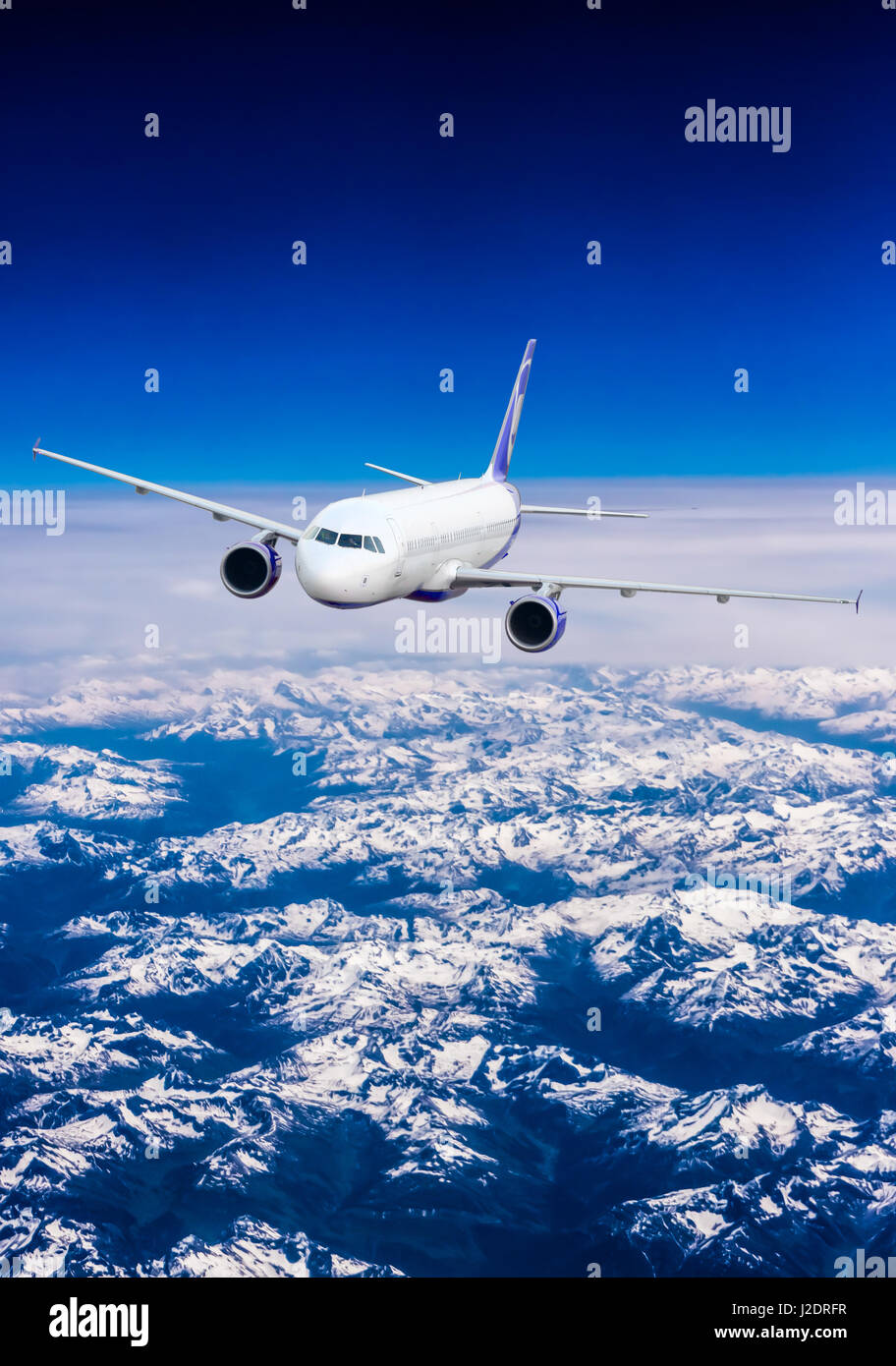 Airplane over the clouds Stock Photo - Alamy