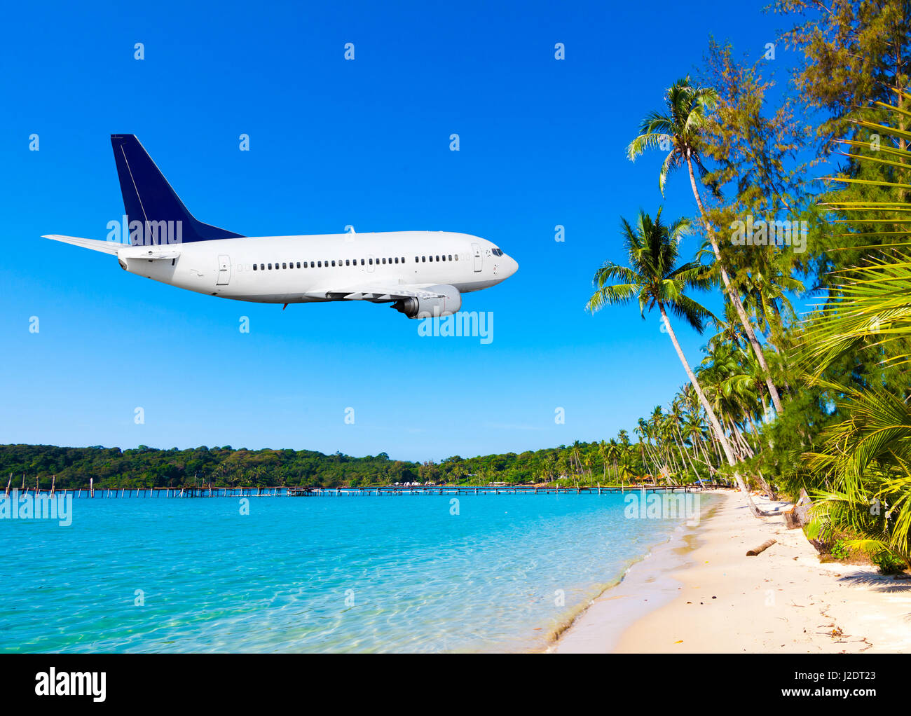 Plane fly over ocean Stock Photo - Alamy