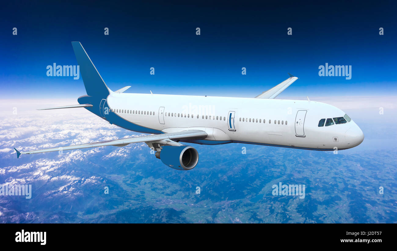 Airplane over the mountains Stock Photo - Alamy