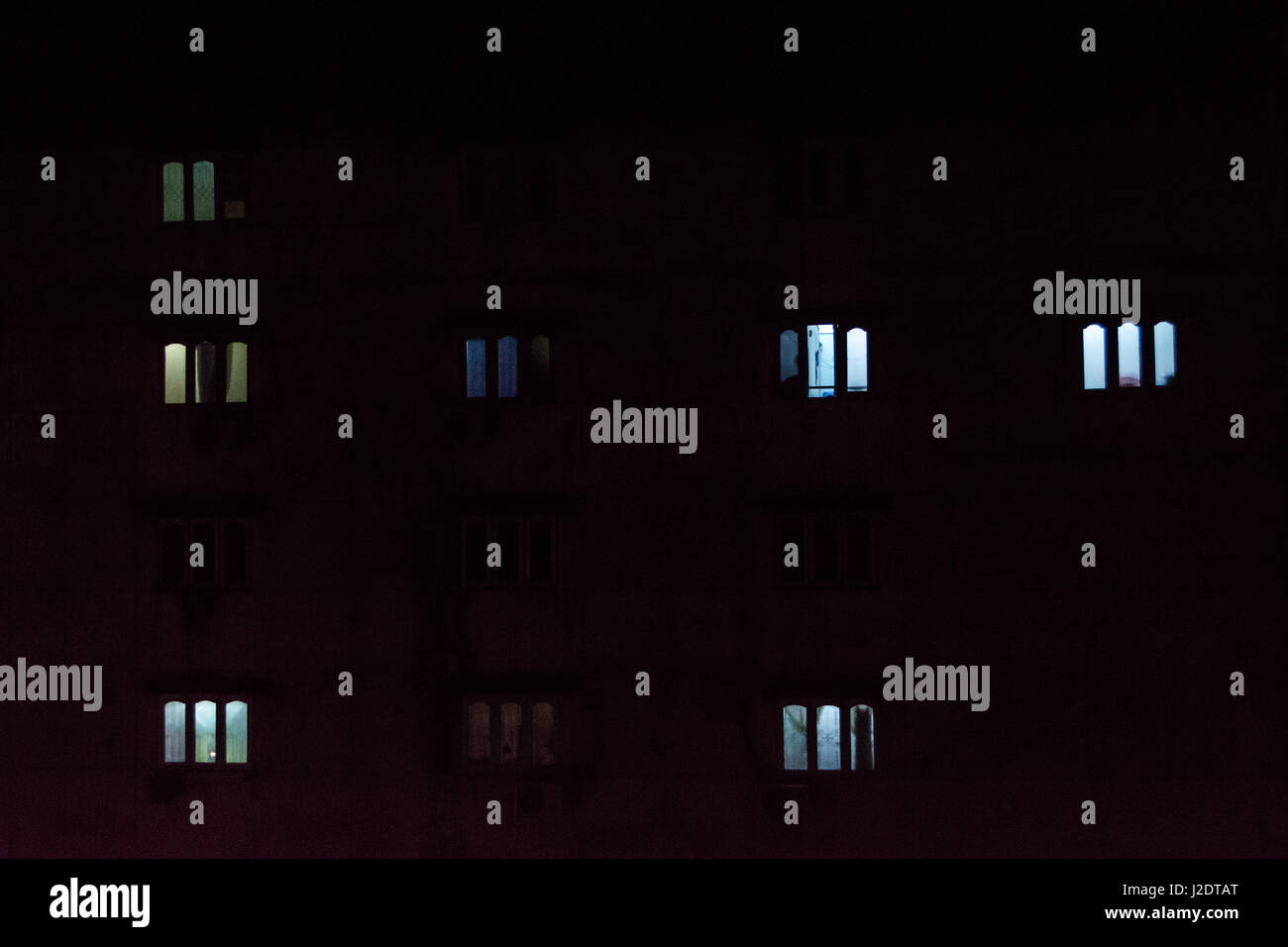 Dim lights from apartment windows at night in Yangon 1 Stock Photo - Alamy