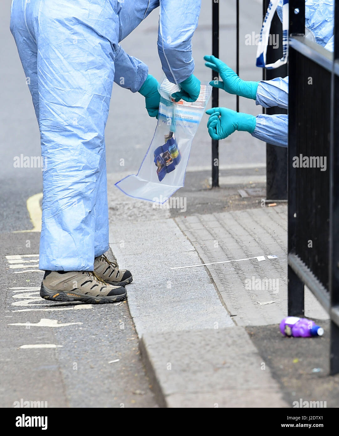 Forensic Officers remove evidence from the scene after a man was ...