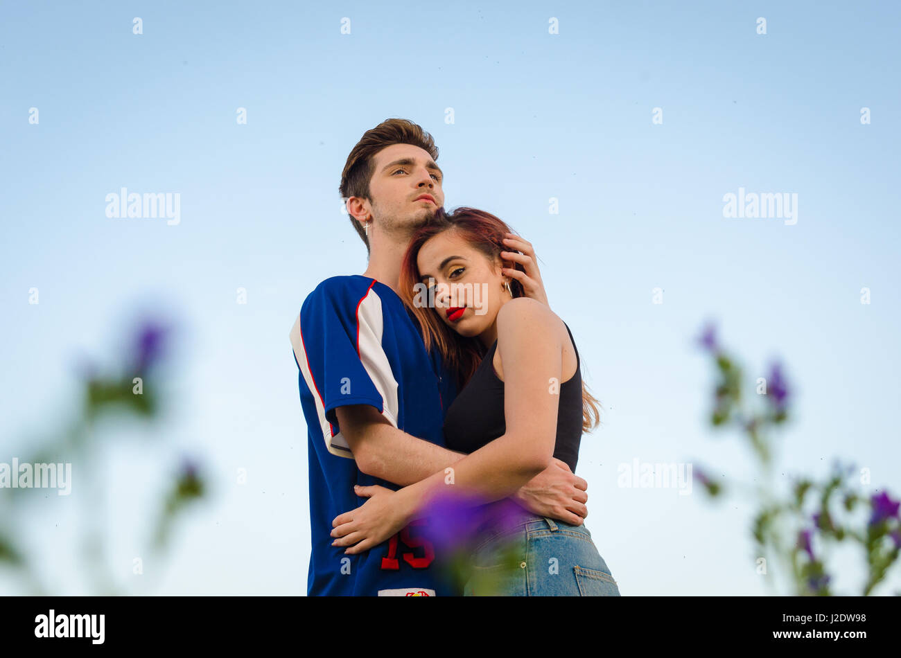 Beautiful young couple in love hugging on outdoor Stock Photo - Alamy