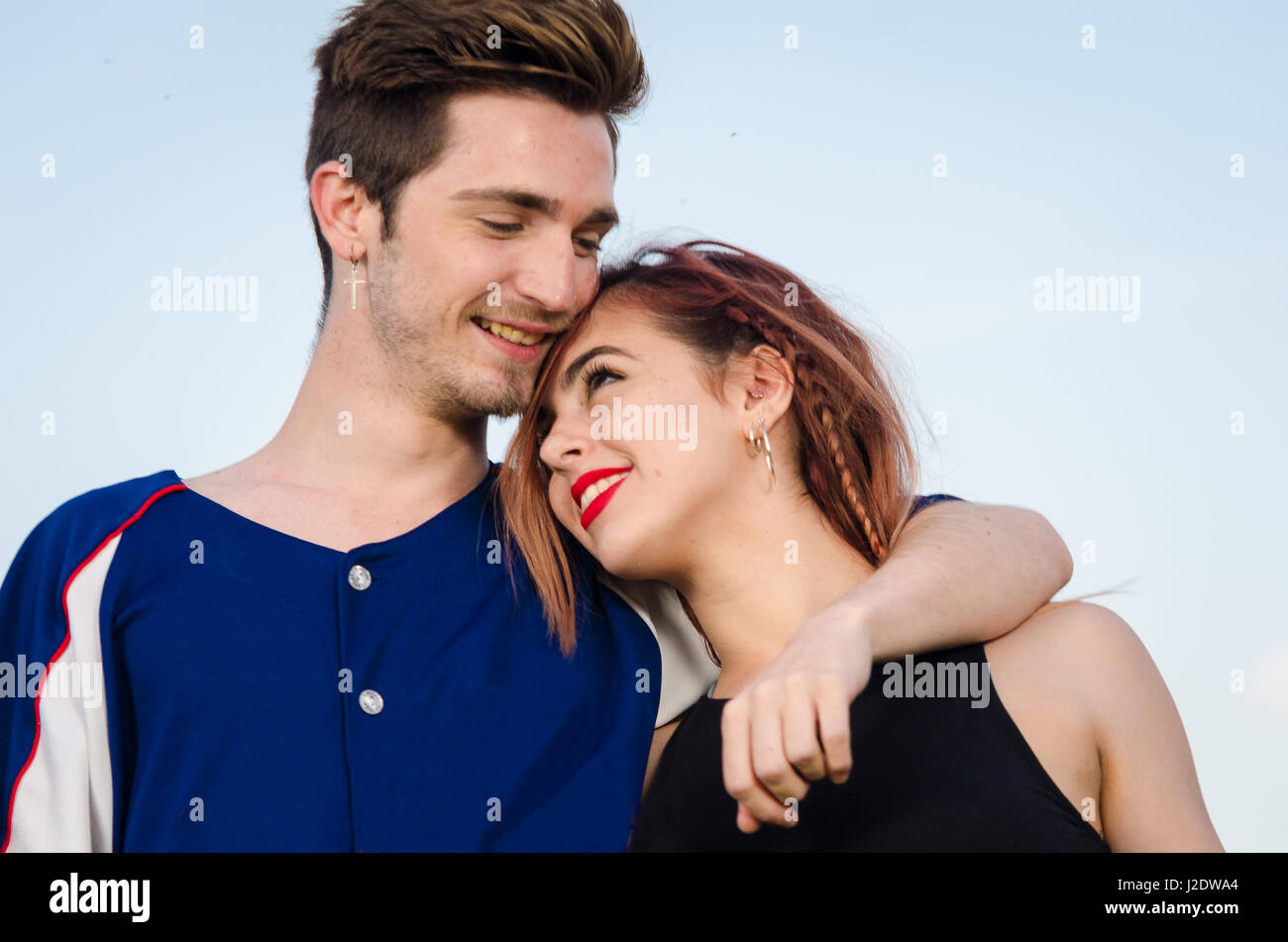 Beautiful young couple in love hugging on outdoor Stock Photo - Alamy