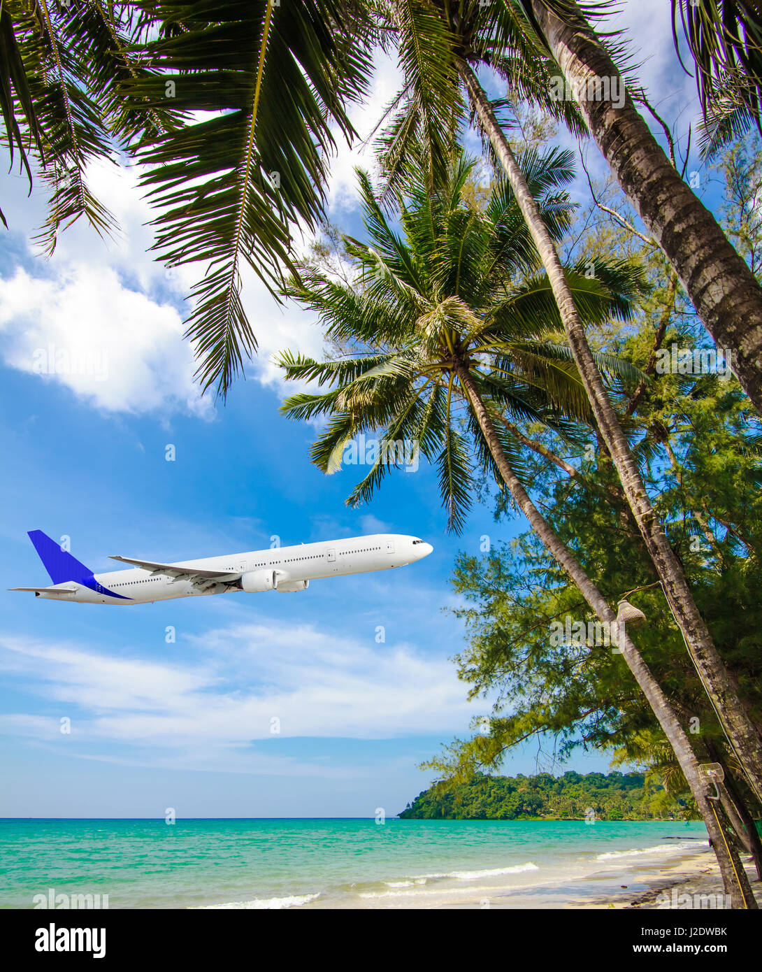 Jet plane over the tropical sea Stock Photo - Alamy