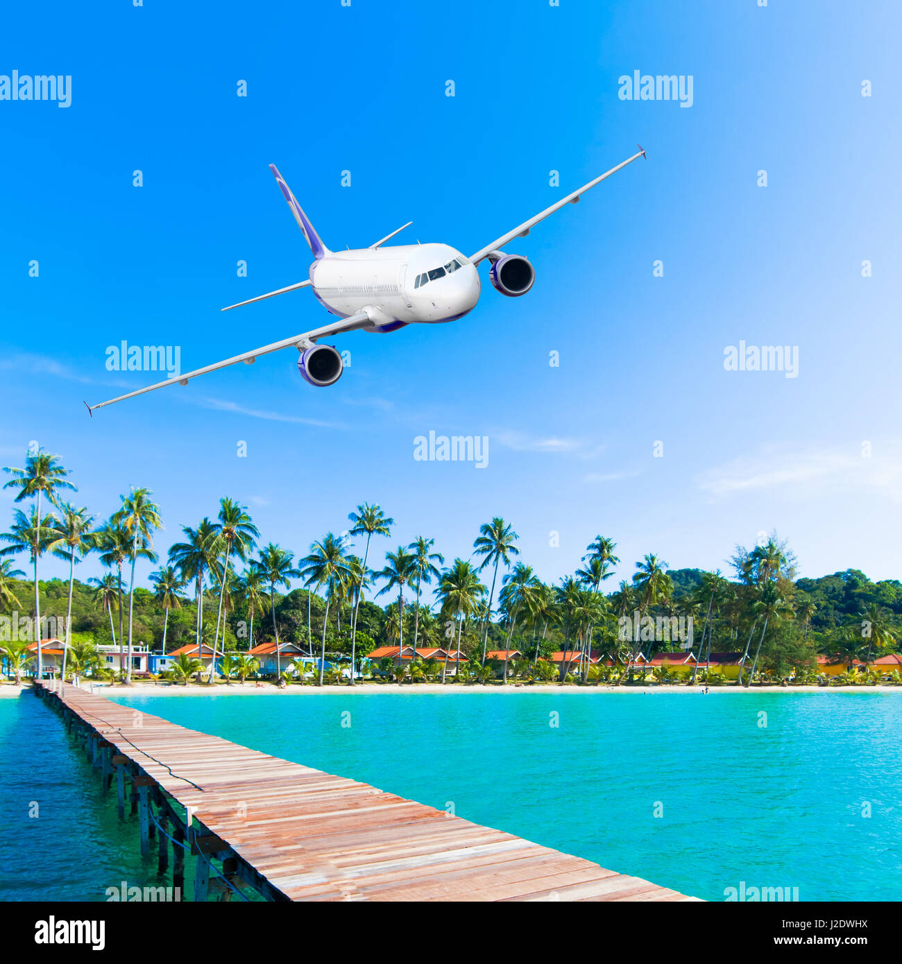 Jet plane over the tropical sea Stock Photo - Alamy