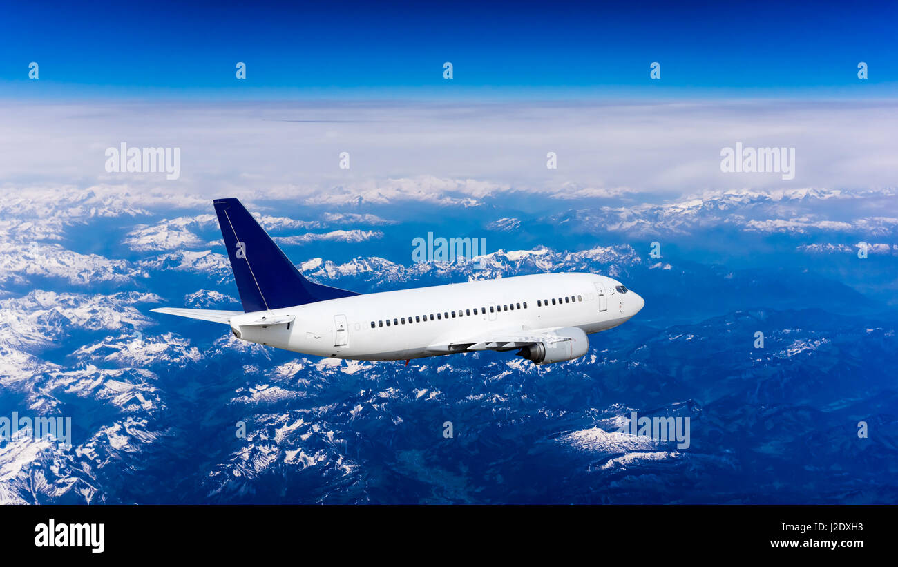 Airplane over the mountains Stock Photo - Alamy