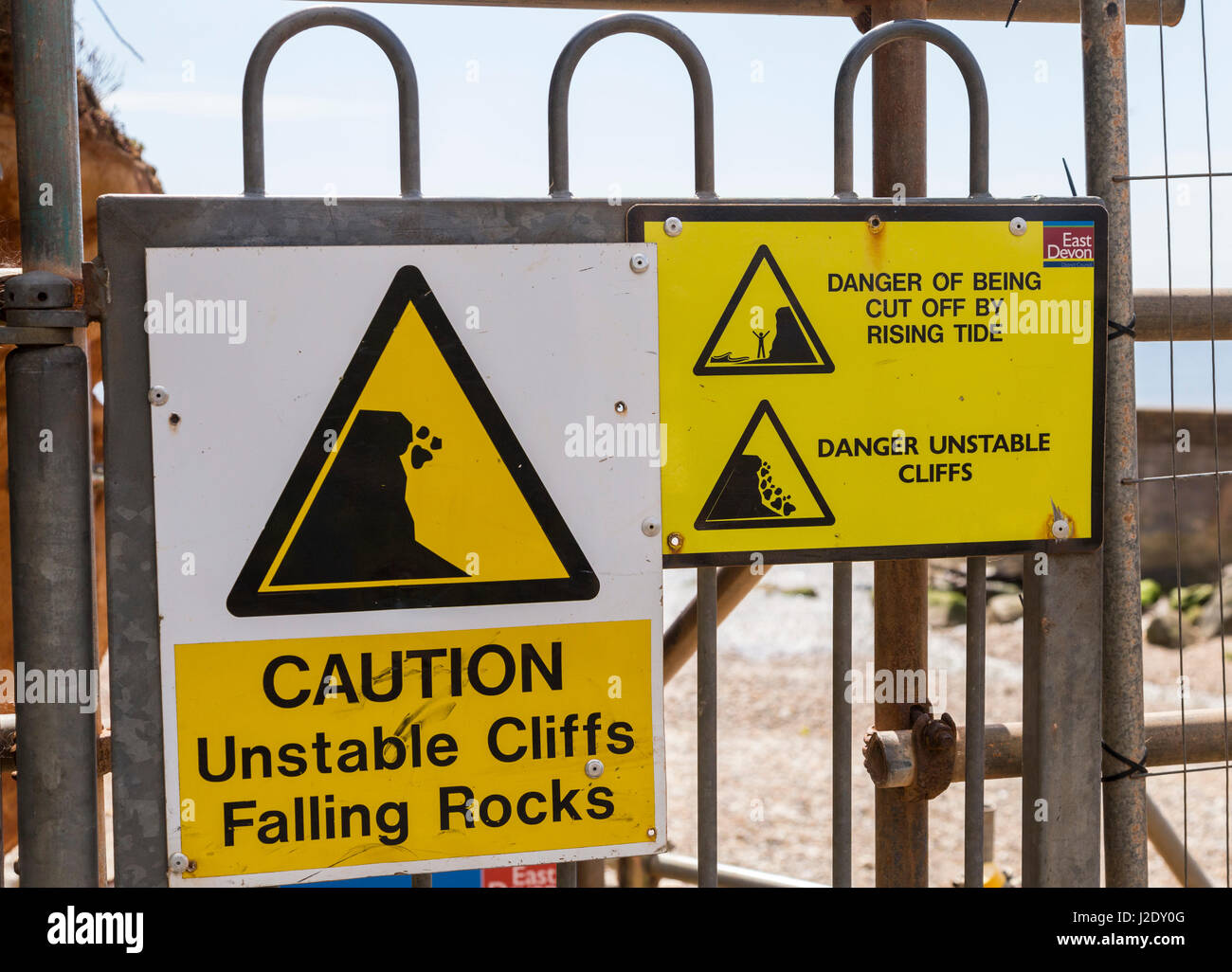 Warning signs beside the unstable cliffs at Sidmouth, which frequently ...