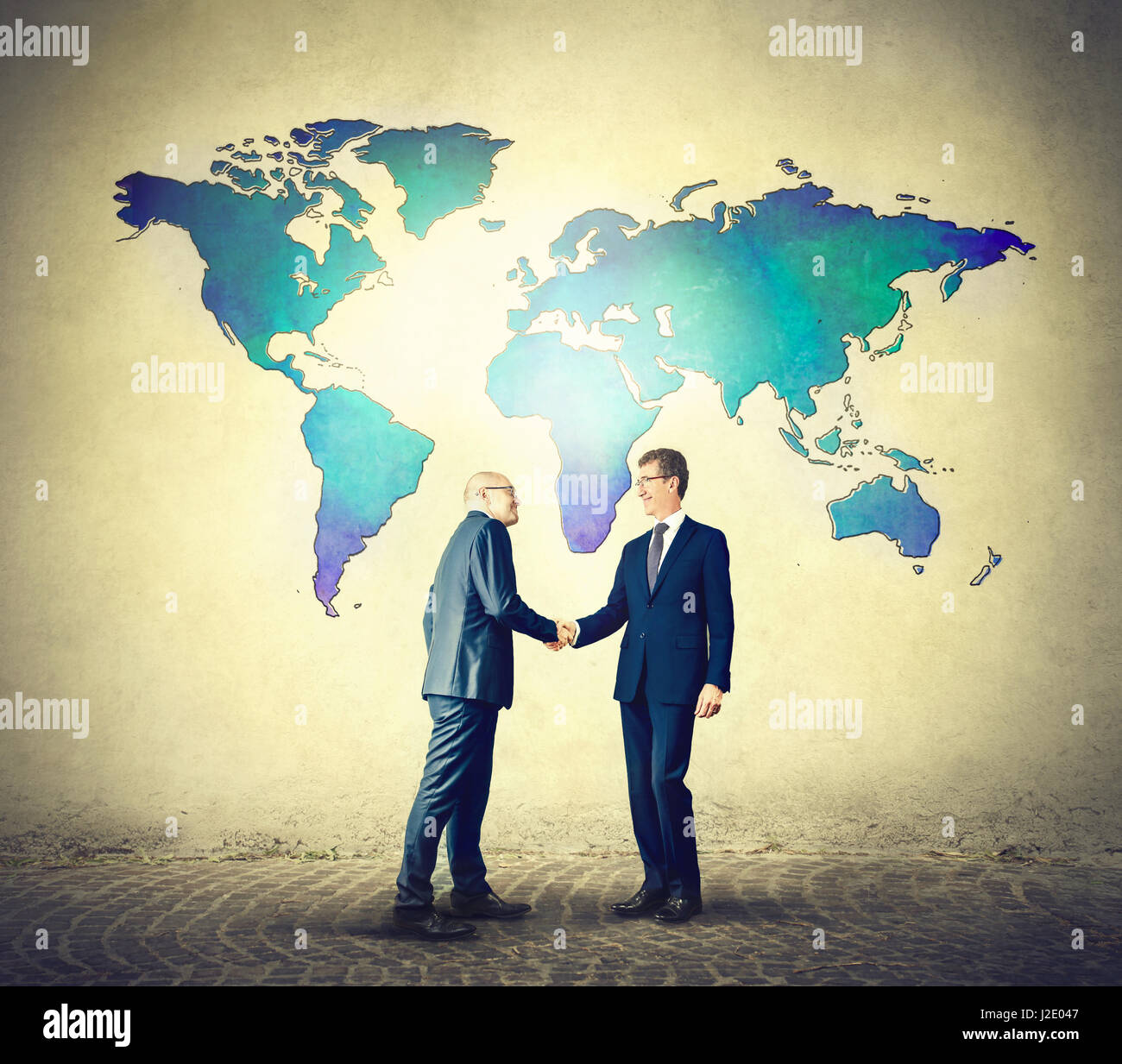 Businessmen shaking hands in front of world map Stock Photo - Alamy