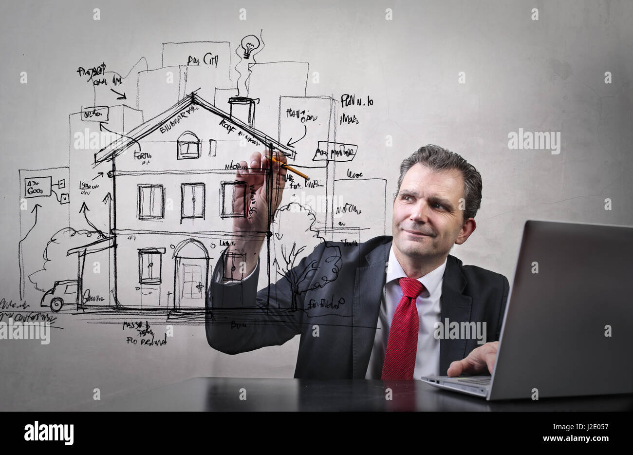 Businessman designing house Stock Photo - Alamy