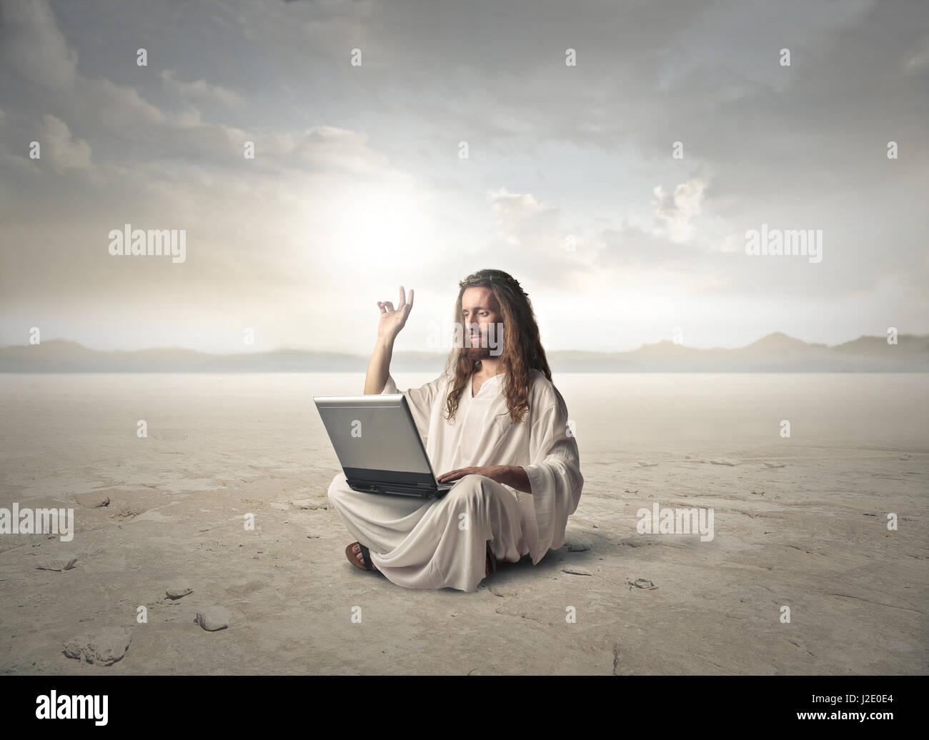 jesus with laptop on empty field Stock Photo - Alamy