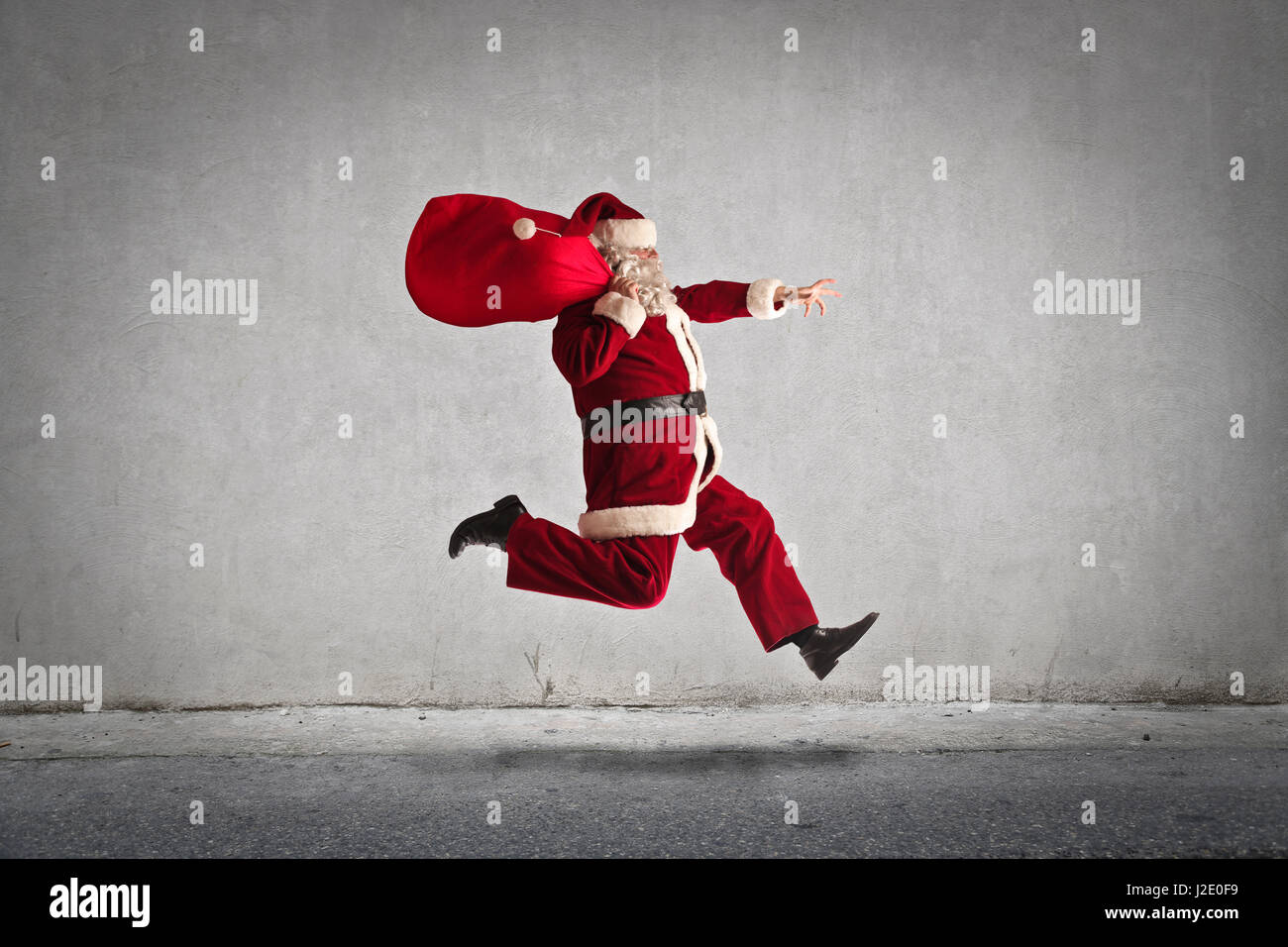 Santa running with full bag Stock Photo - Alamy