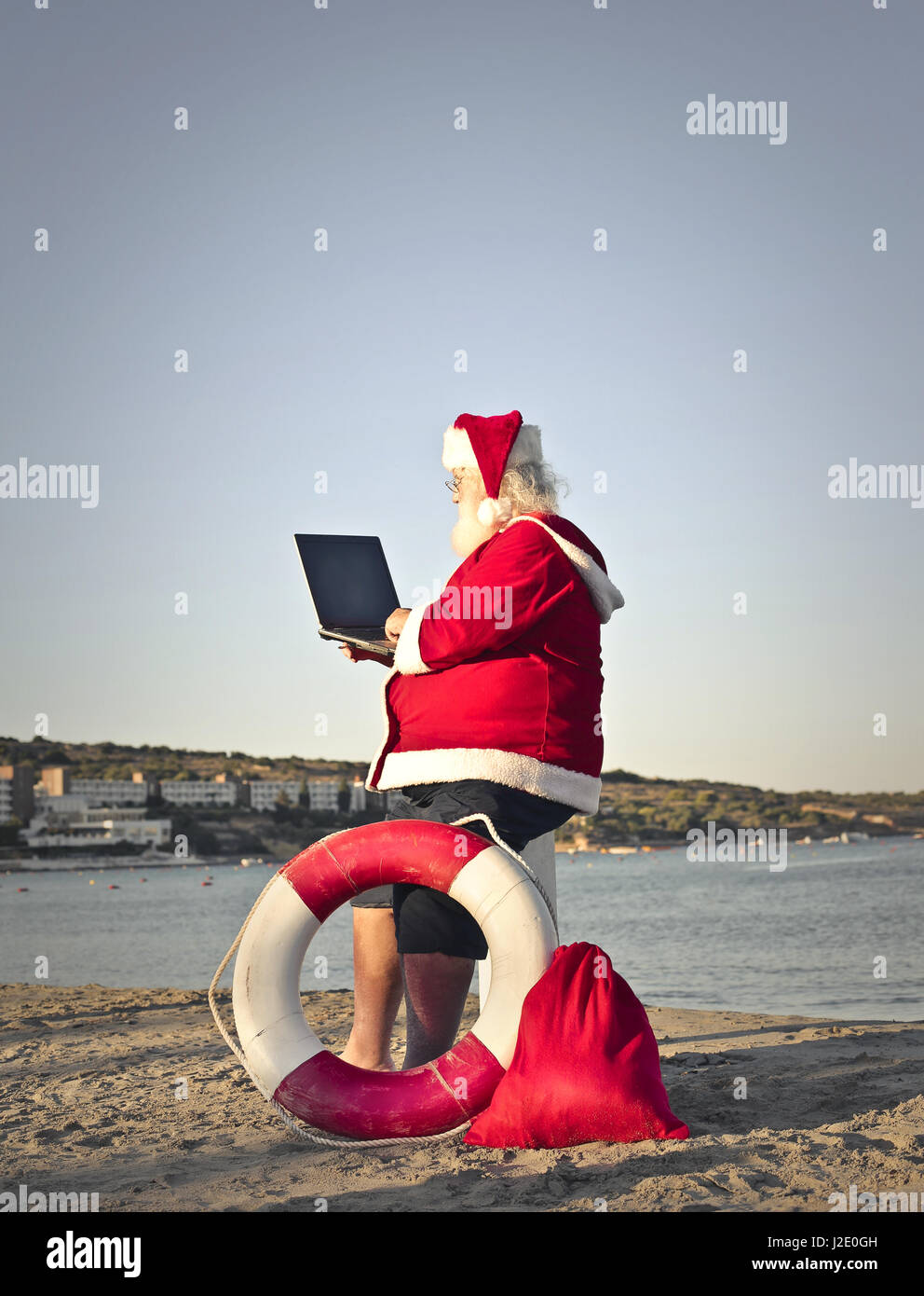 Santa with laptop outside Stock Photo - Alamy