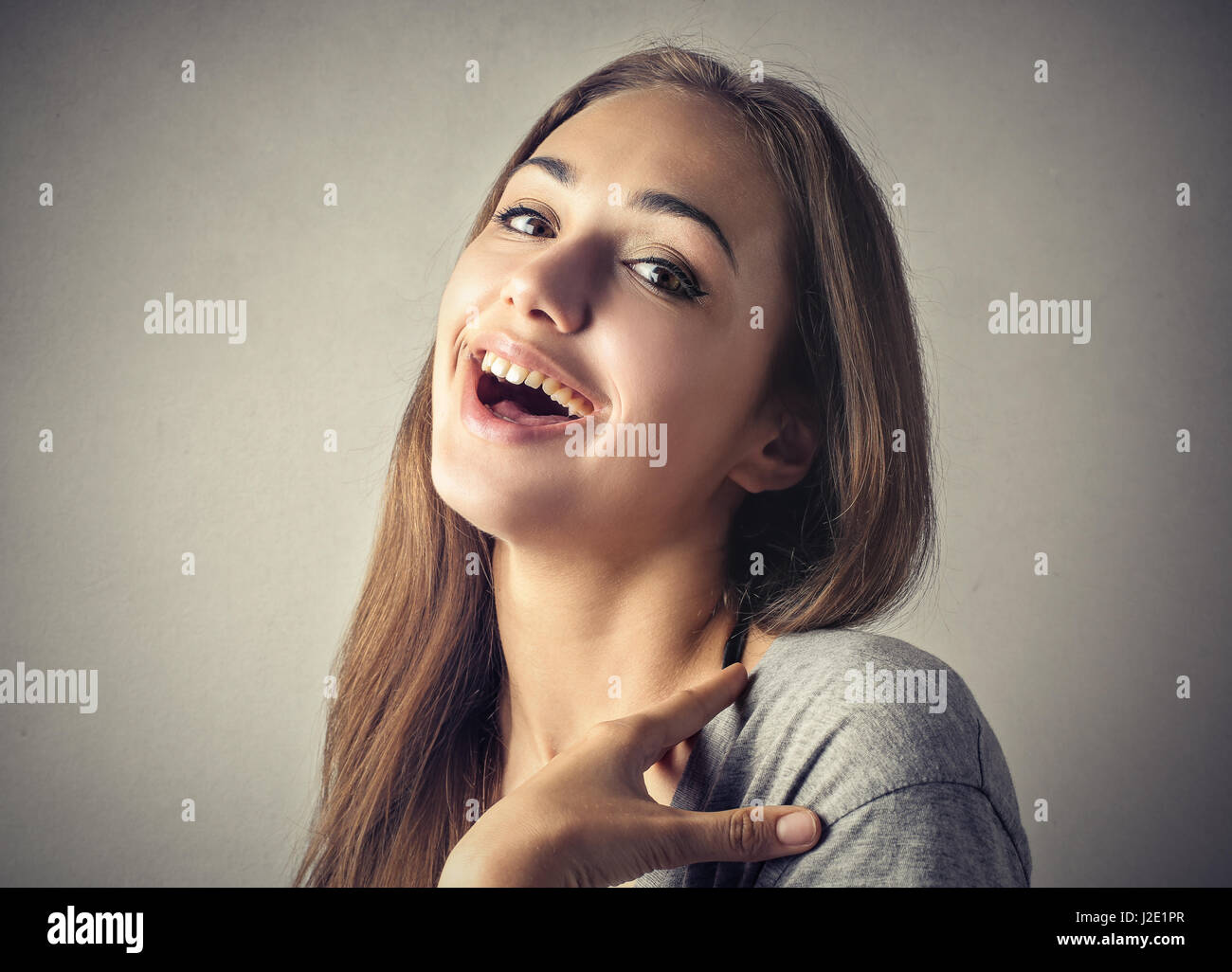 Brunette woman laughing inside Stock Photo - Alamy